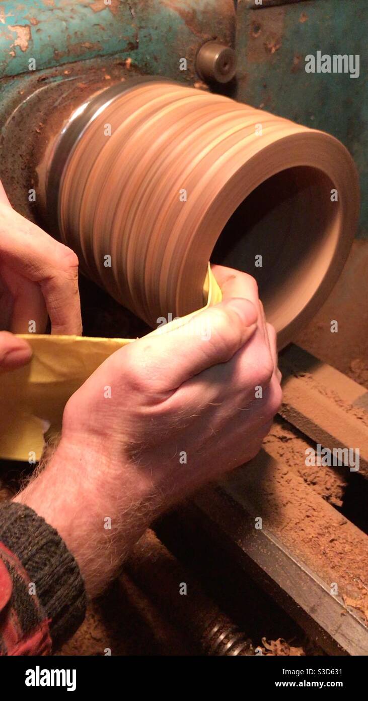Sanding on a lathe Stock Photo - Alamy