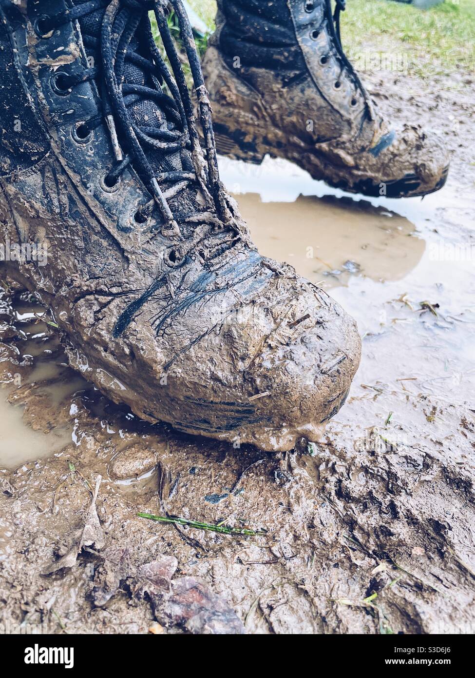 Muddy boots and puddles Stock Photo - Alamy