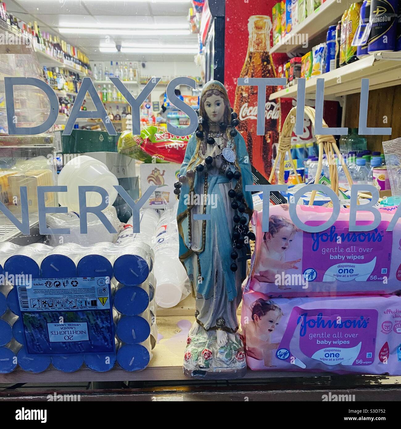 Praying statue of mother Mary wrapped in rosary beads on display at the ...