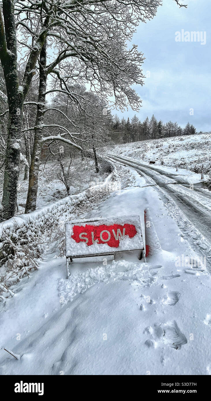 Slow sign in snow Stock Photo - Alamy