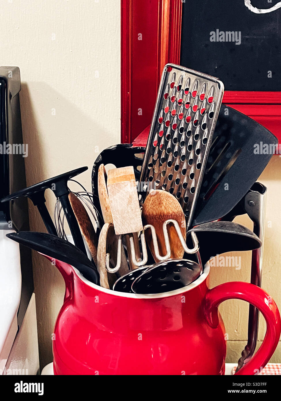 Kitchen utensils in red pitcher Stock Photo - Alamy