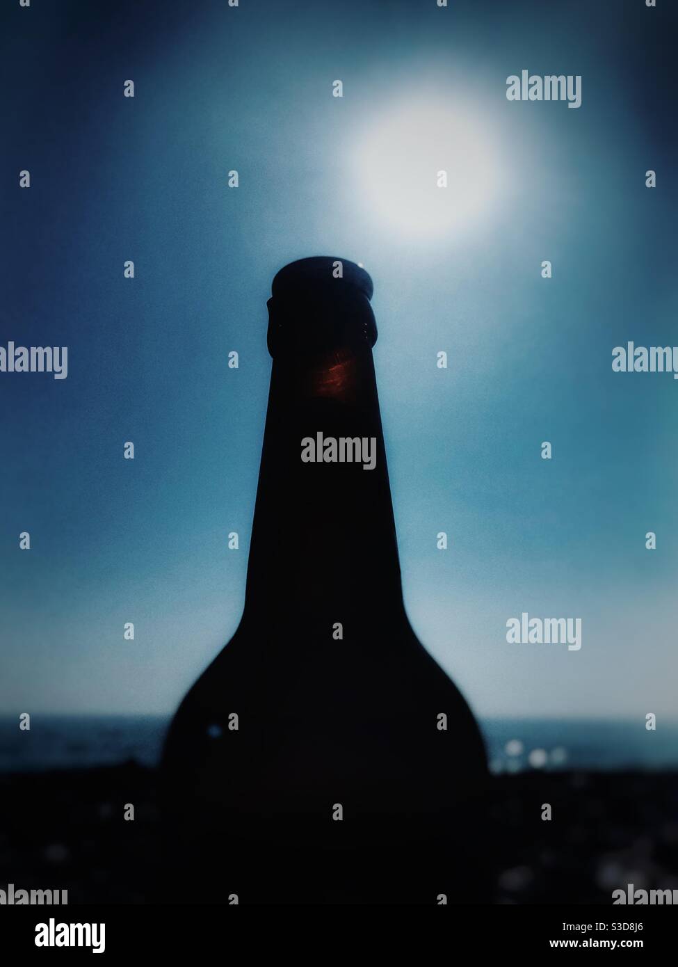 Beer bottle against bright sun light Stock Photo - Alamy