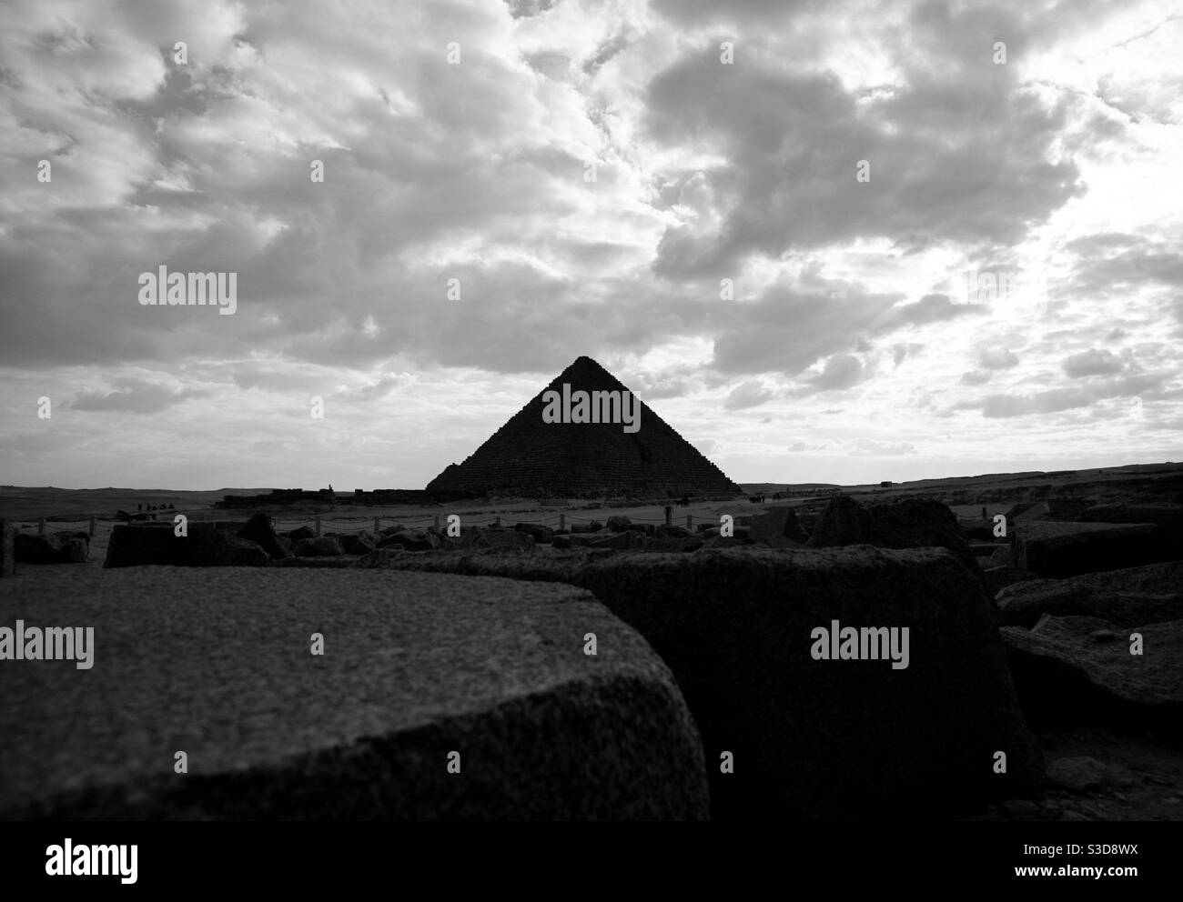 a black and white shot of one of the pyramids of Egypt in a cloudy day ...