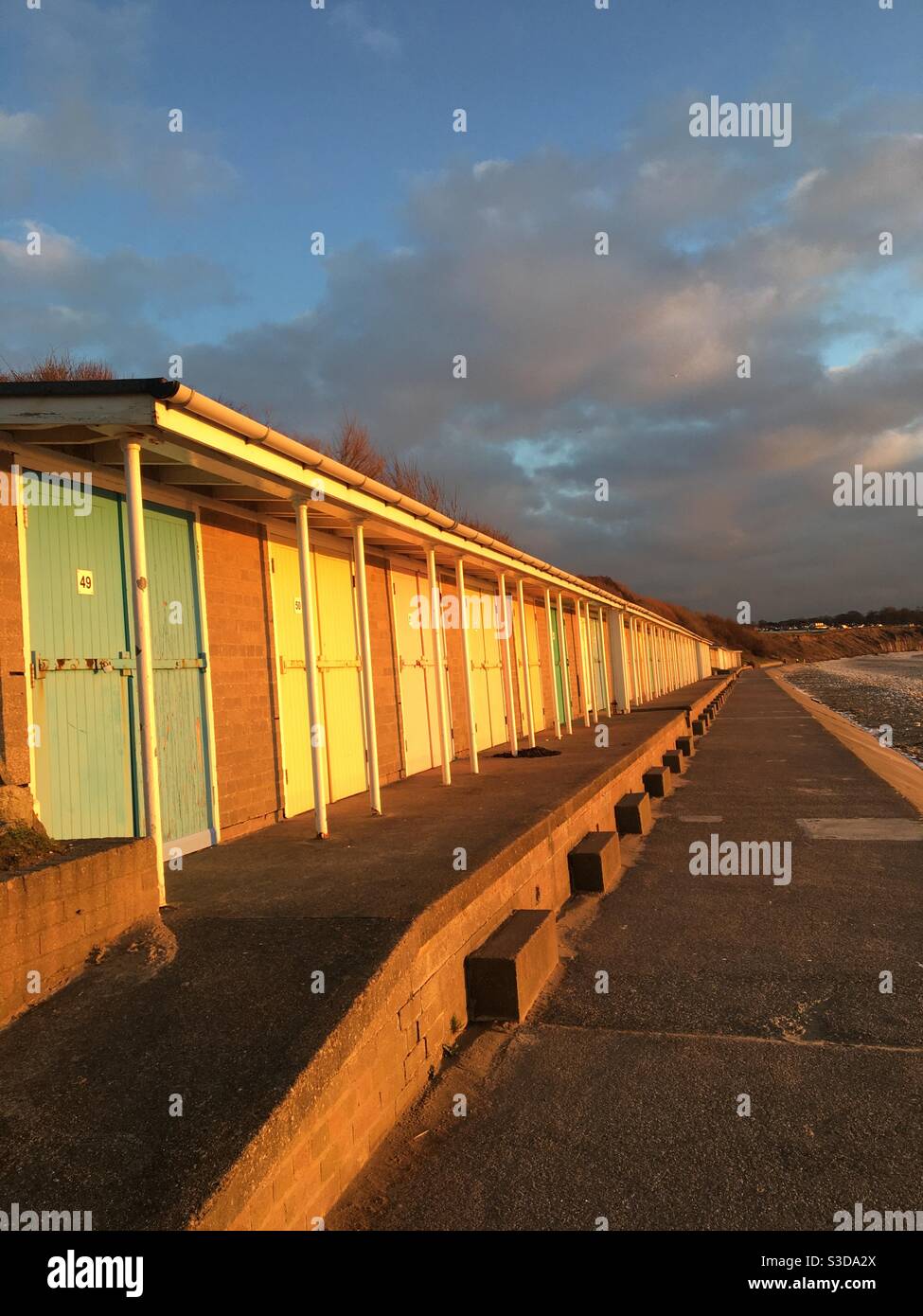 Colourful beach chalets in the sunshine Stock Photo - Alamy