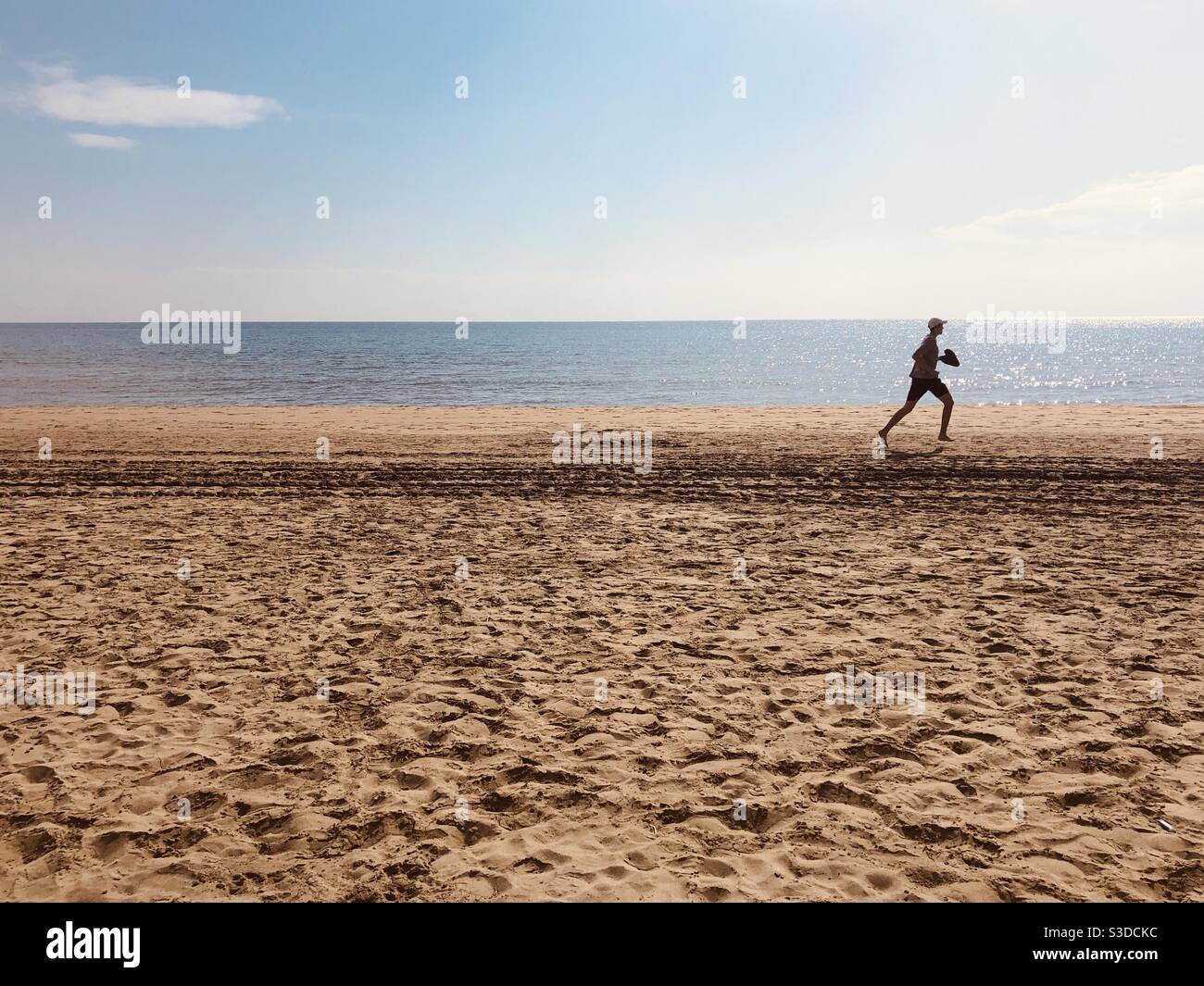 Man running on the beach Stock Photo - Alamy