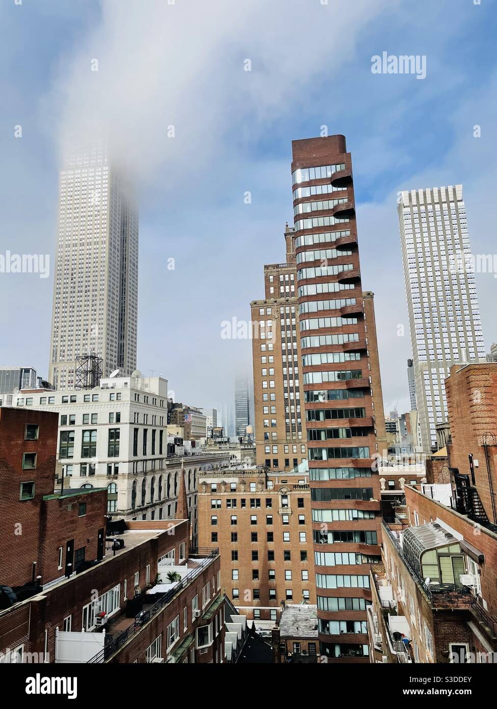 A single cloud embraces the top of the Empire State building on a cold ...