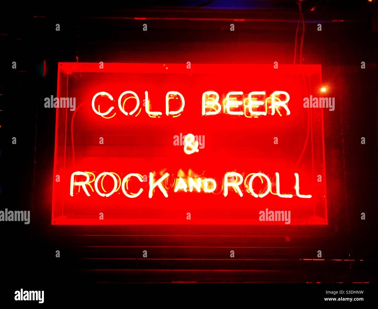 Cold beer & Rock and roll red neon sign, pubs reopening Stock Photo - Alamy