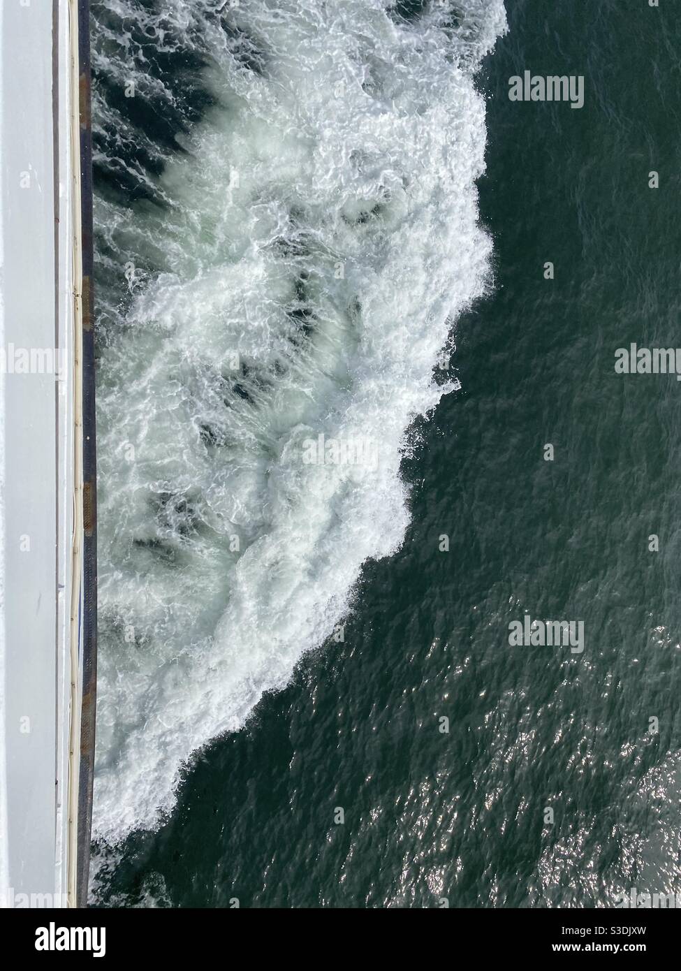 Waves formed from a boat moving through water Stock Photo - Alamy