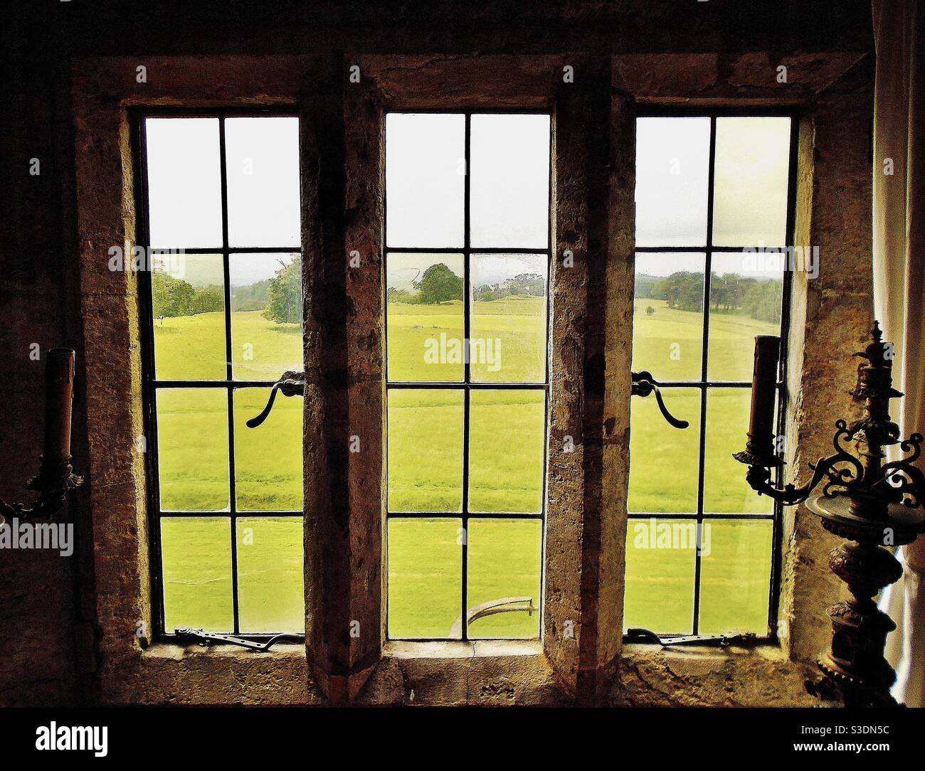 View through a rustic cottage window overlooking the English ...