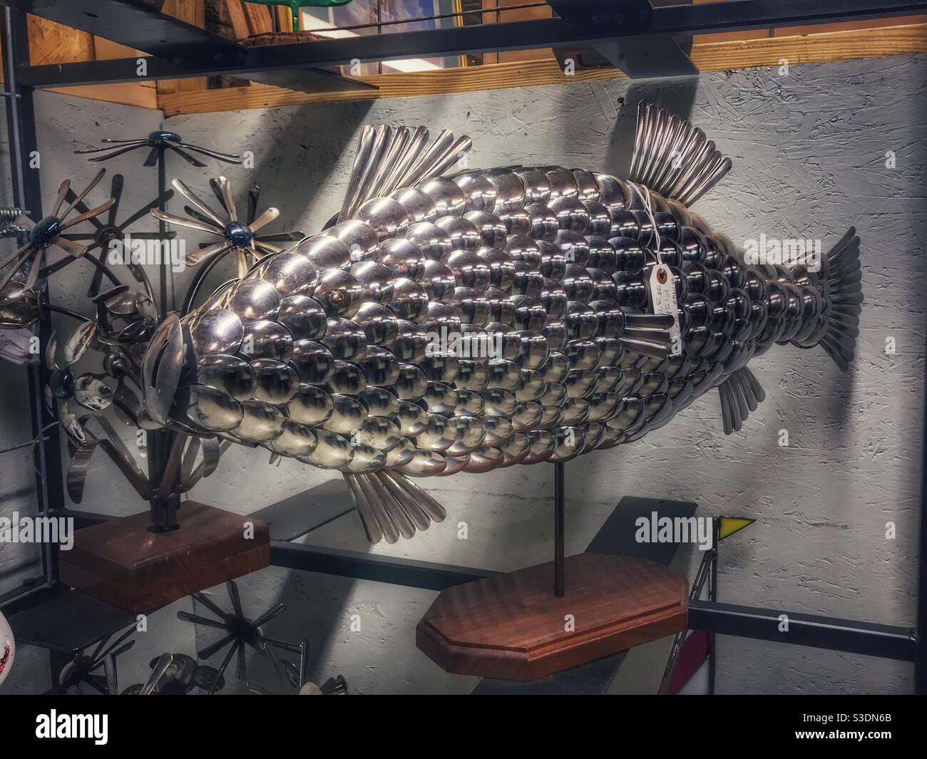 Fish sculpture made from silver spoons displayed at antique mall Stock ...