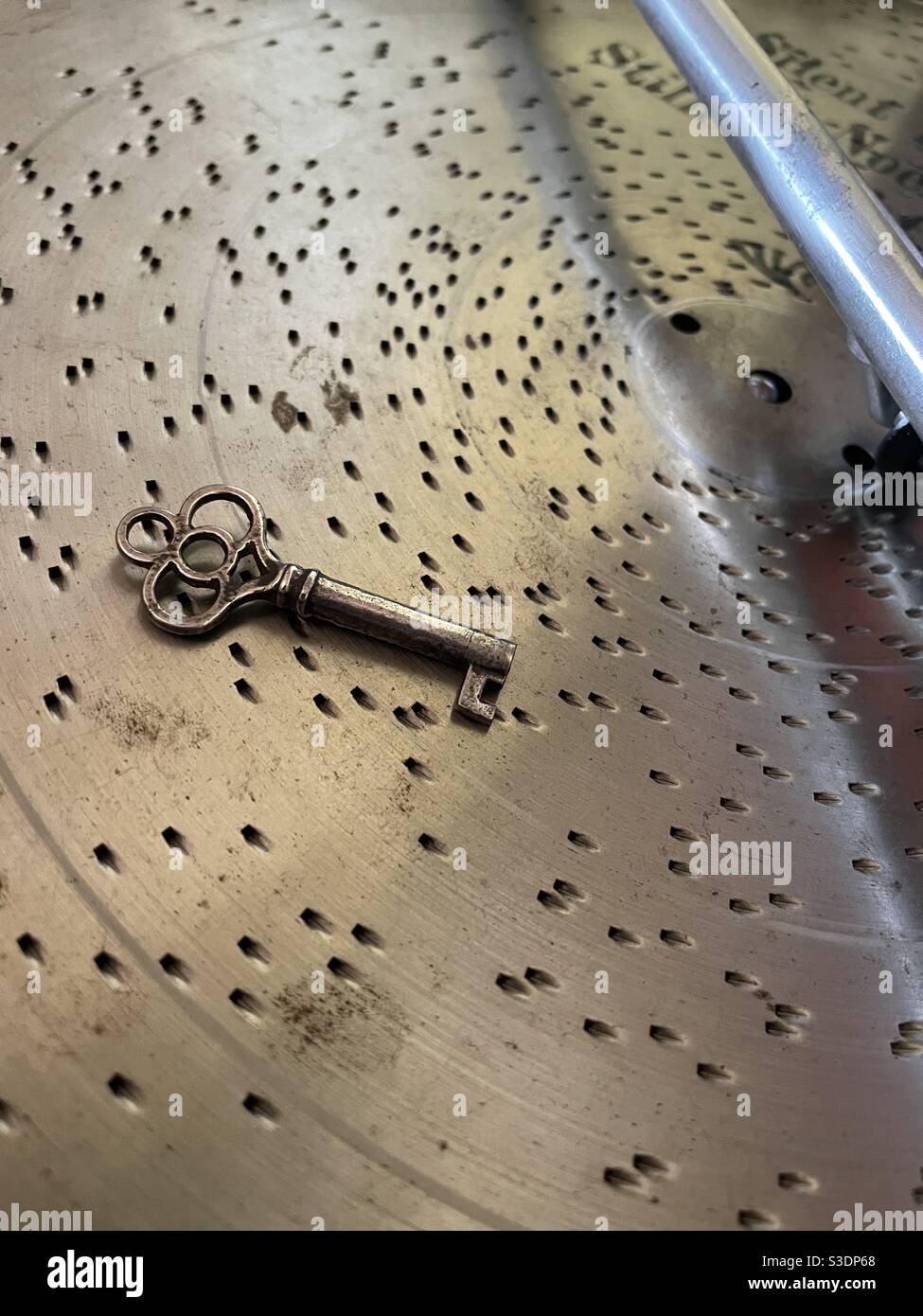 Music box key on metal disk Stock Photo - Alamy