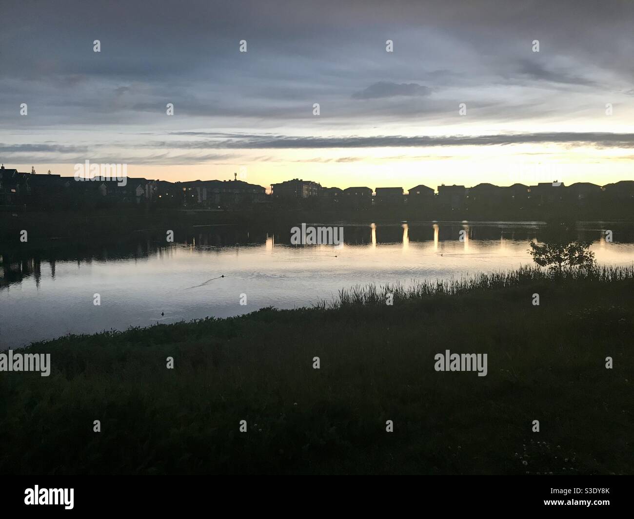 A sunset over a neighbourhood pond Stock Photo - Alamy