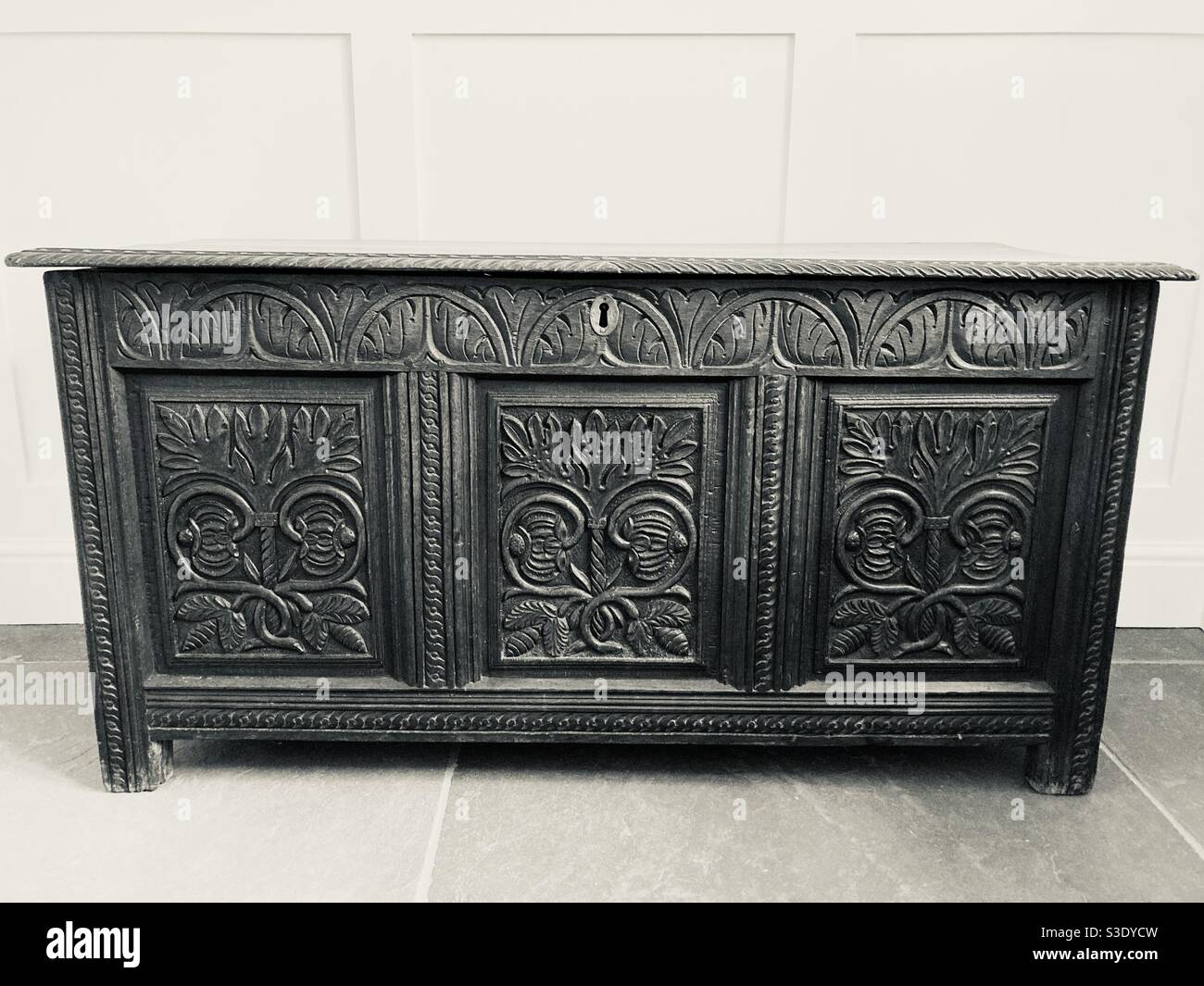 Ornate and intricately carved wooden storage chest on limestone floor ...