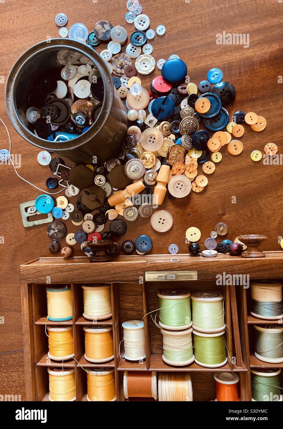 Sewing buttons and thread on a table Stock Photo - Alamy