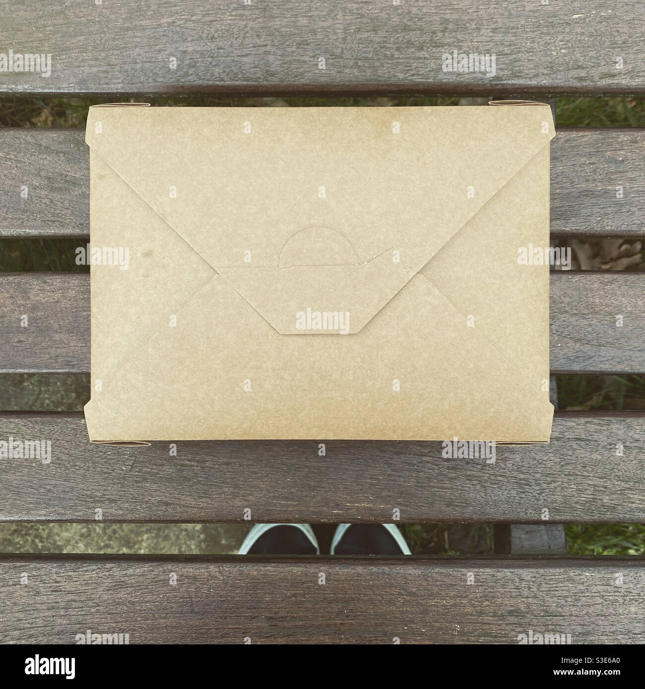 Cardboard box on a bench outdoors Stock Photo - Alamy