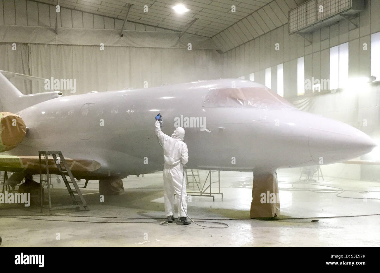 Private Jet being painted Stock Photo - Alamy