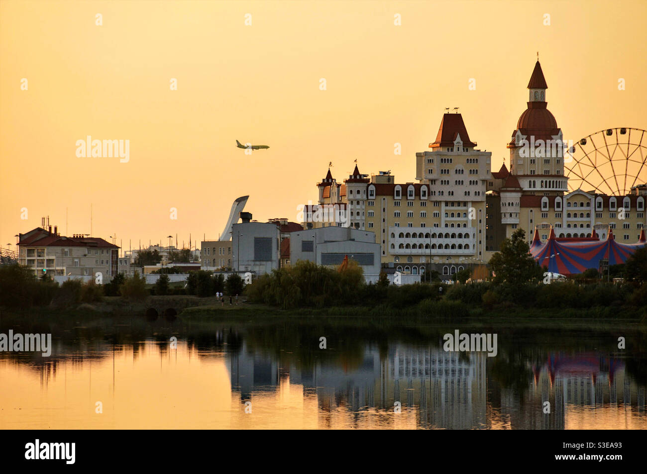 Beautiful buildings, airplane silhouette, reflection in water and ...