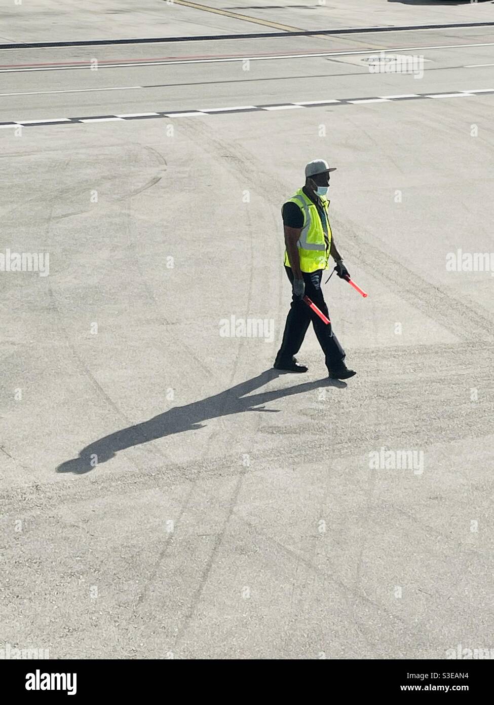 Aircraft marshaller on snowy tarmac Stock Photo - Alamy
