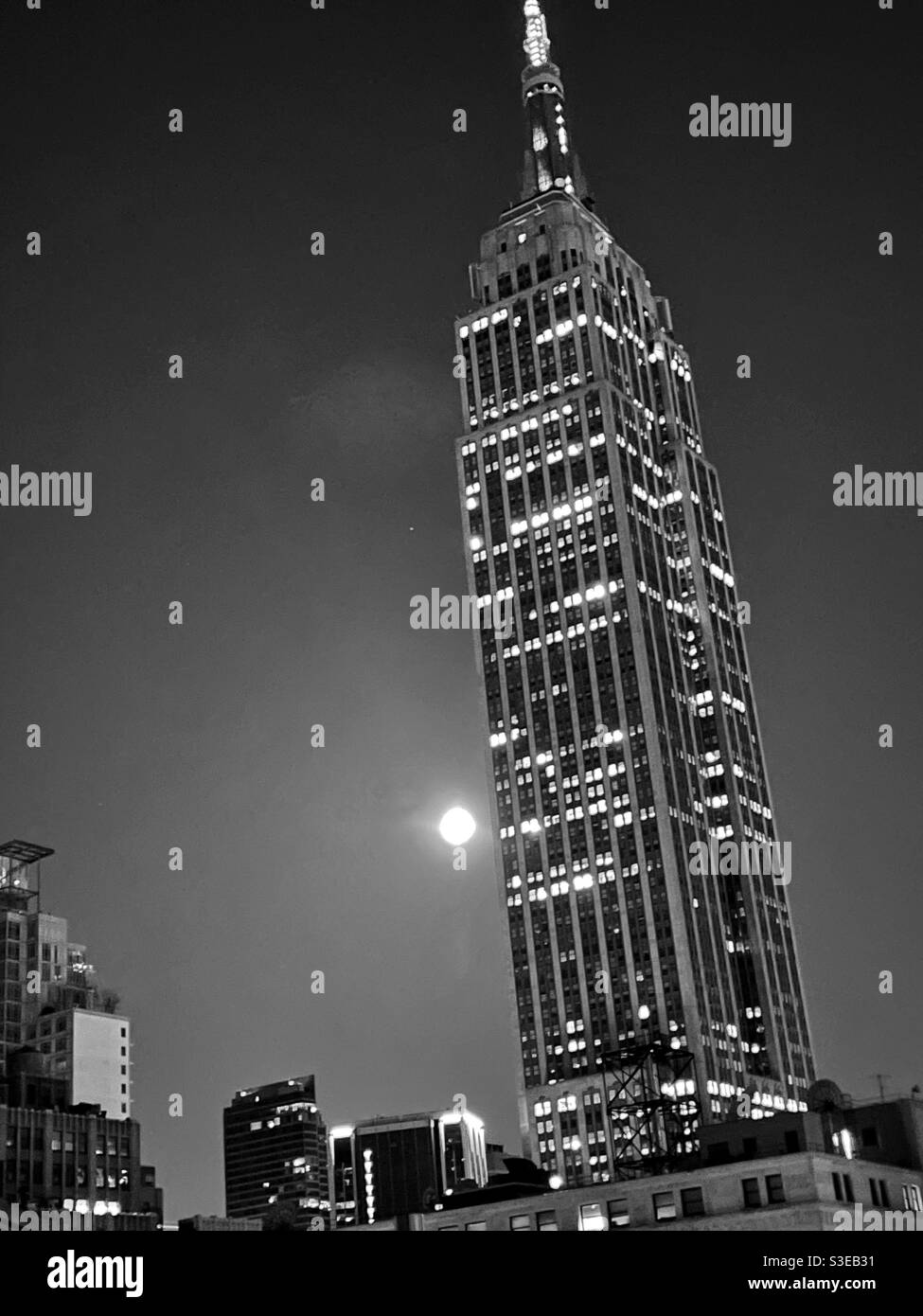 Full moon by Empire State Building Stock Photo - Alamy