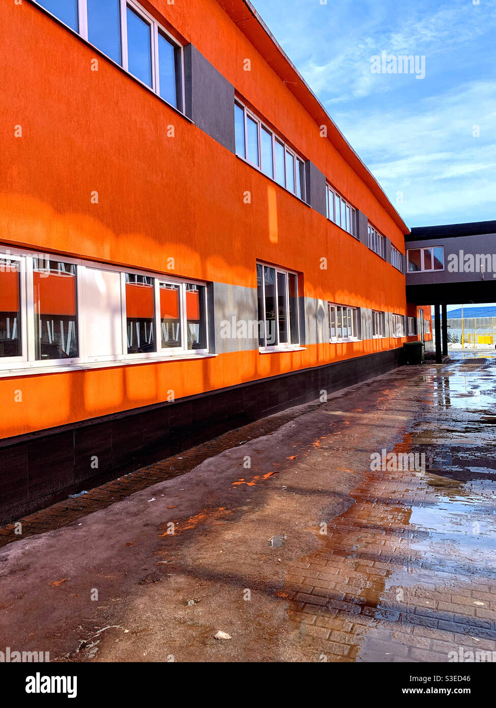 Long orange building receding into the distance Stock Photo - Alamy