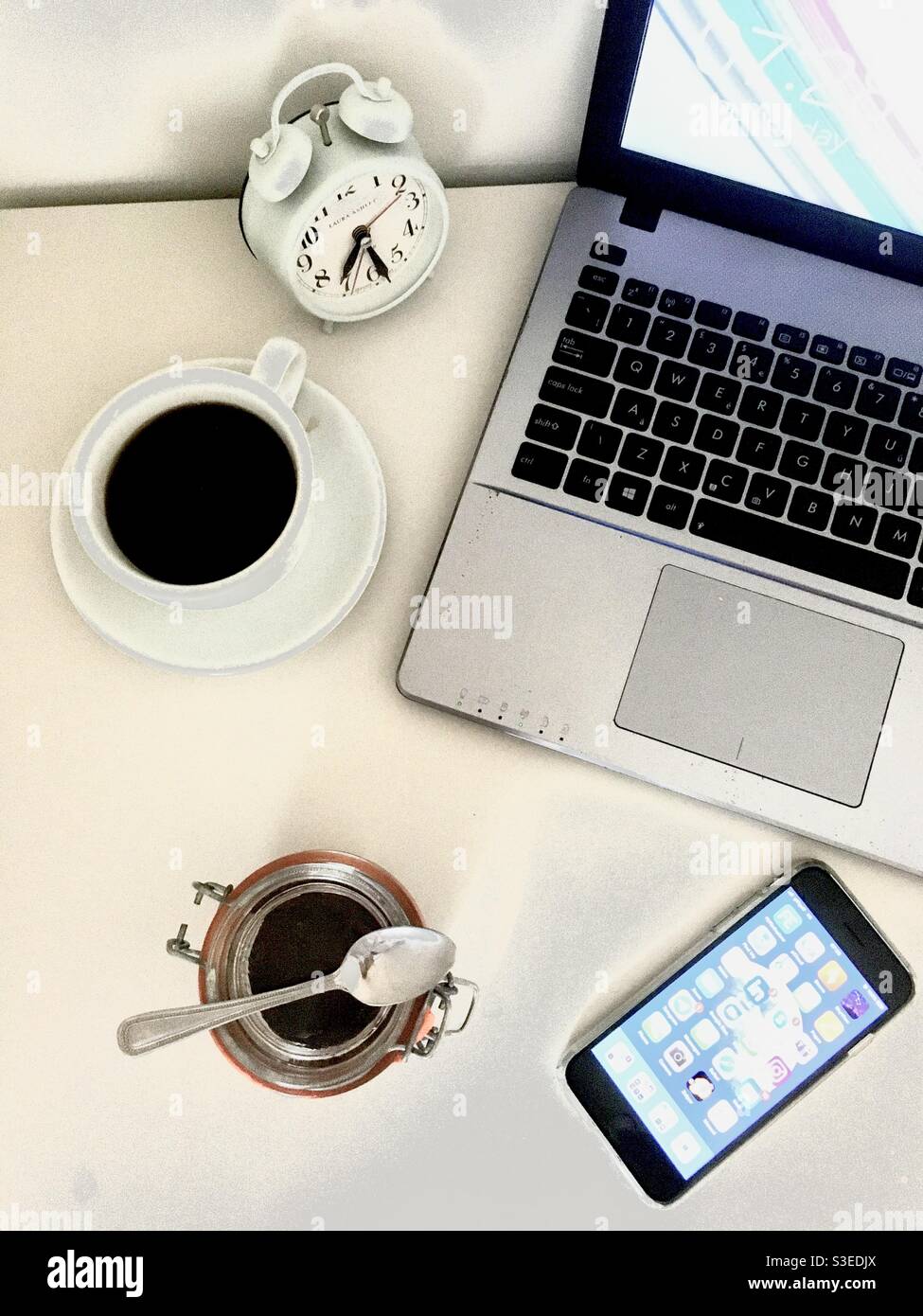 Working from home laptop and clock hi-res stock photography and images ...