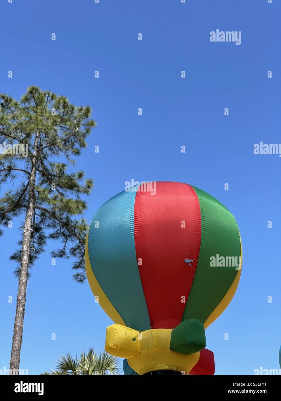 Colorful blow up balloon with blue sky background Stock Photo - Alamy