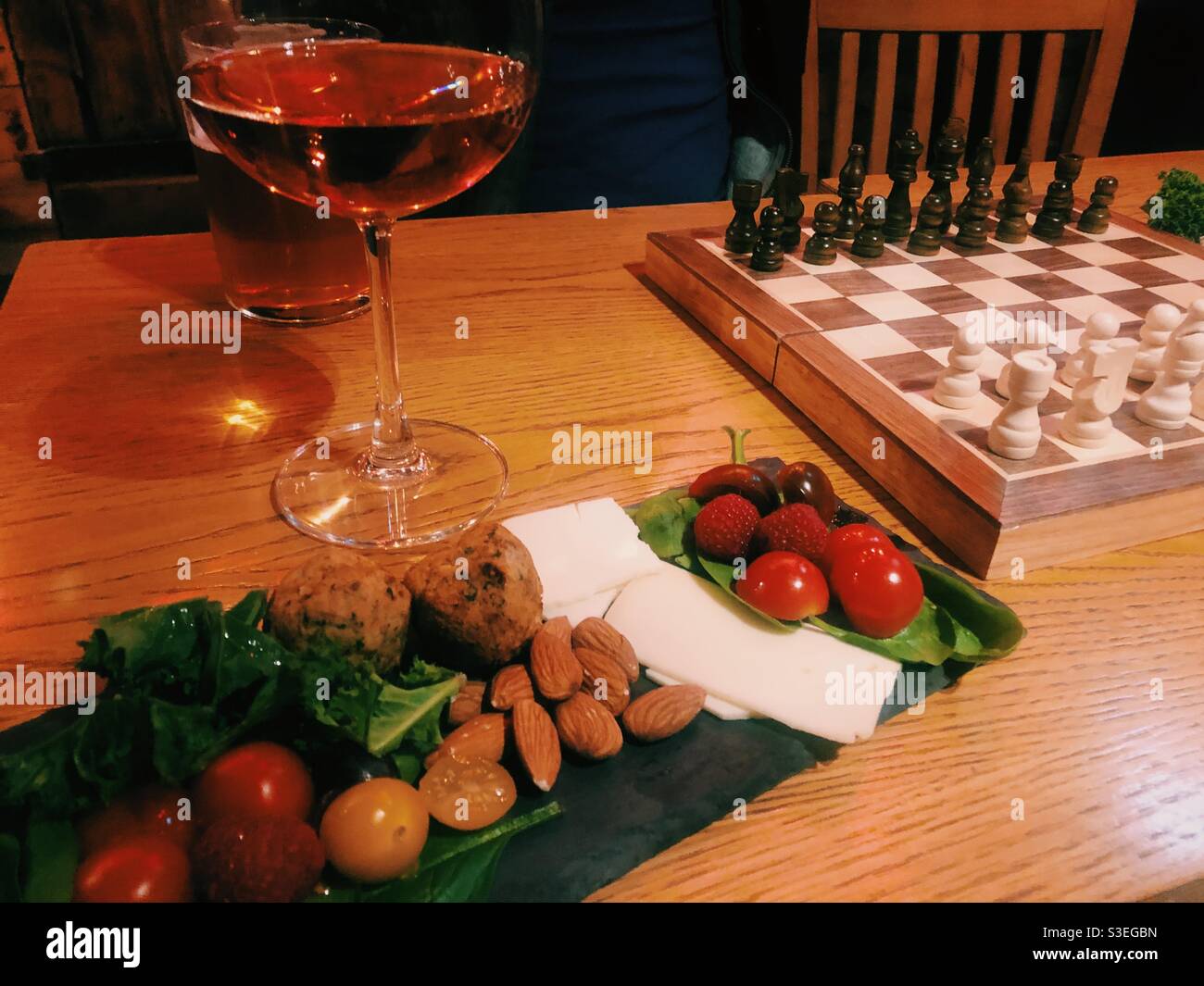 Vegan cheese board with wine and chess Stock Photo - Alamy