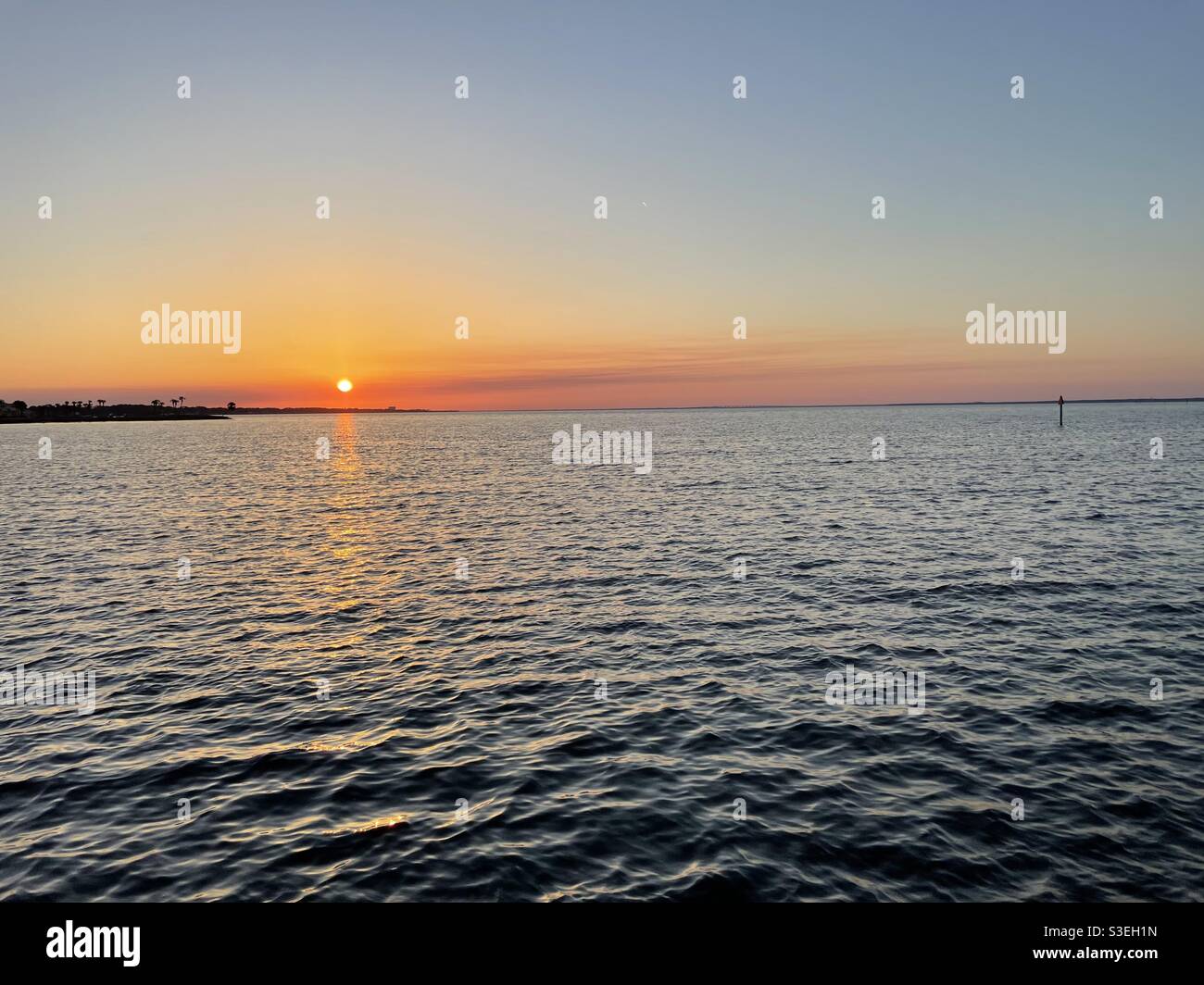 Colorful sunset skies over bay water Emerald Coast Florida Stock Photo ...