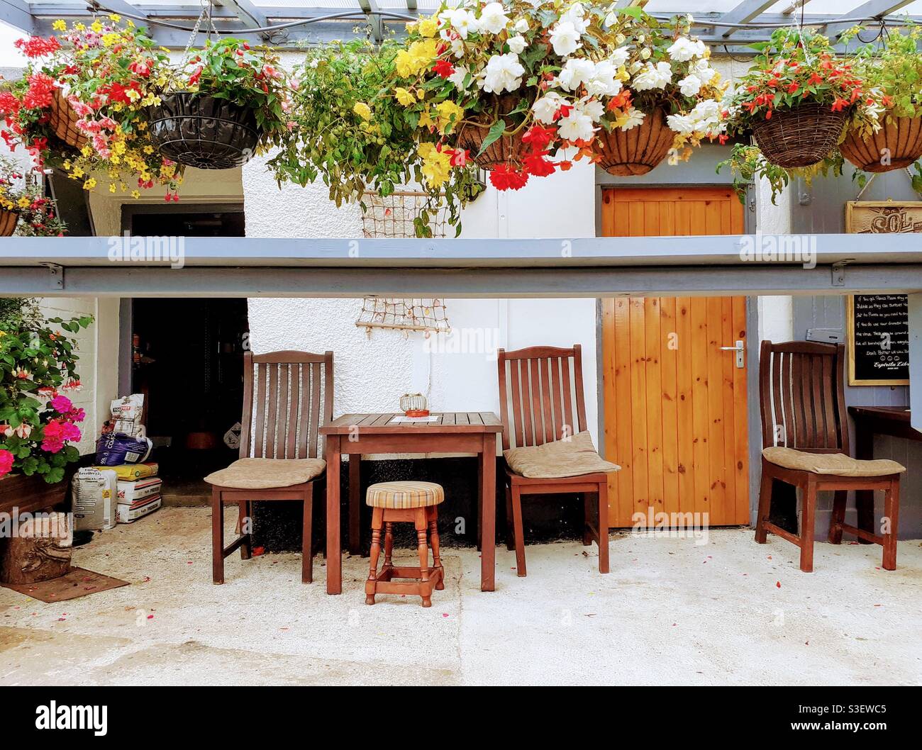 Rustic terrace with flowers and wood furniture Stock Photo - Alamy