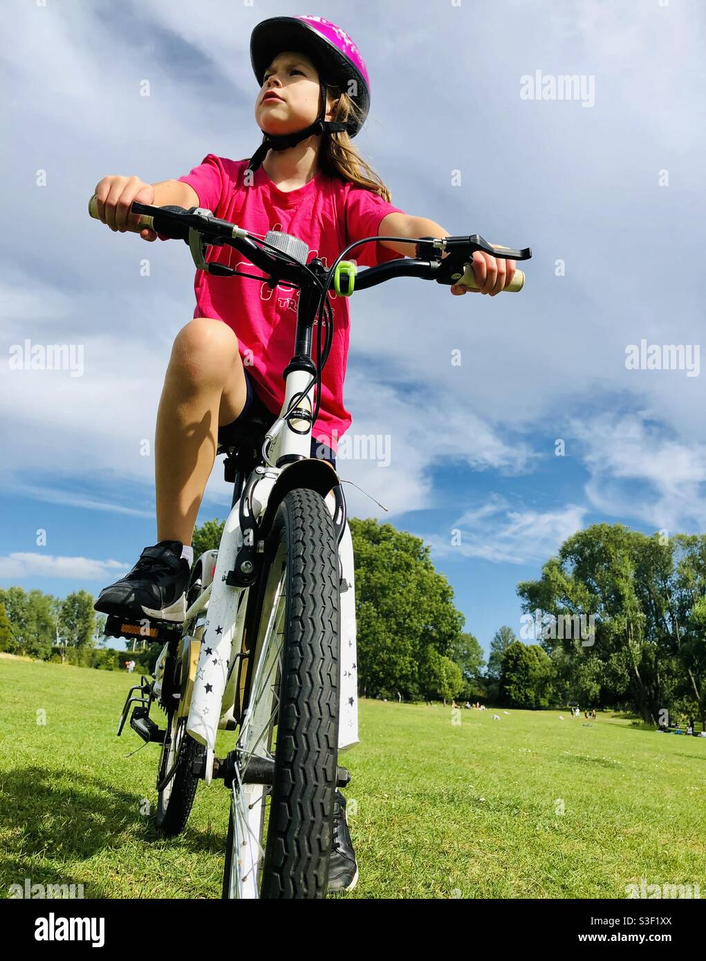 Girl riding bicycle Stock Photo - Alamy
