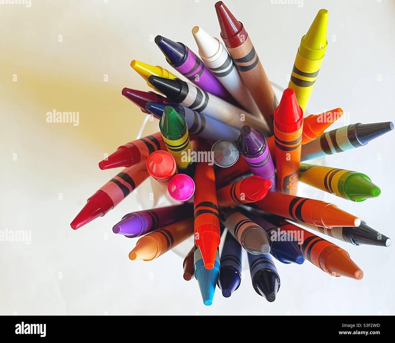 Still life of a grouping of crayons in a colorful array shot from above ...