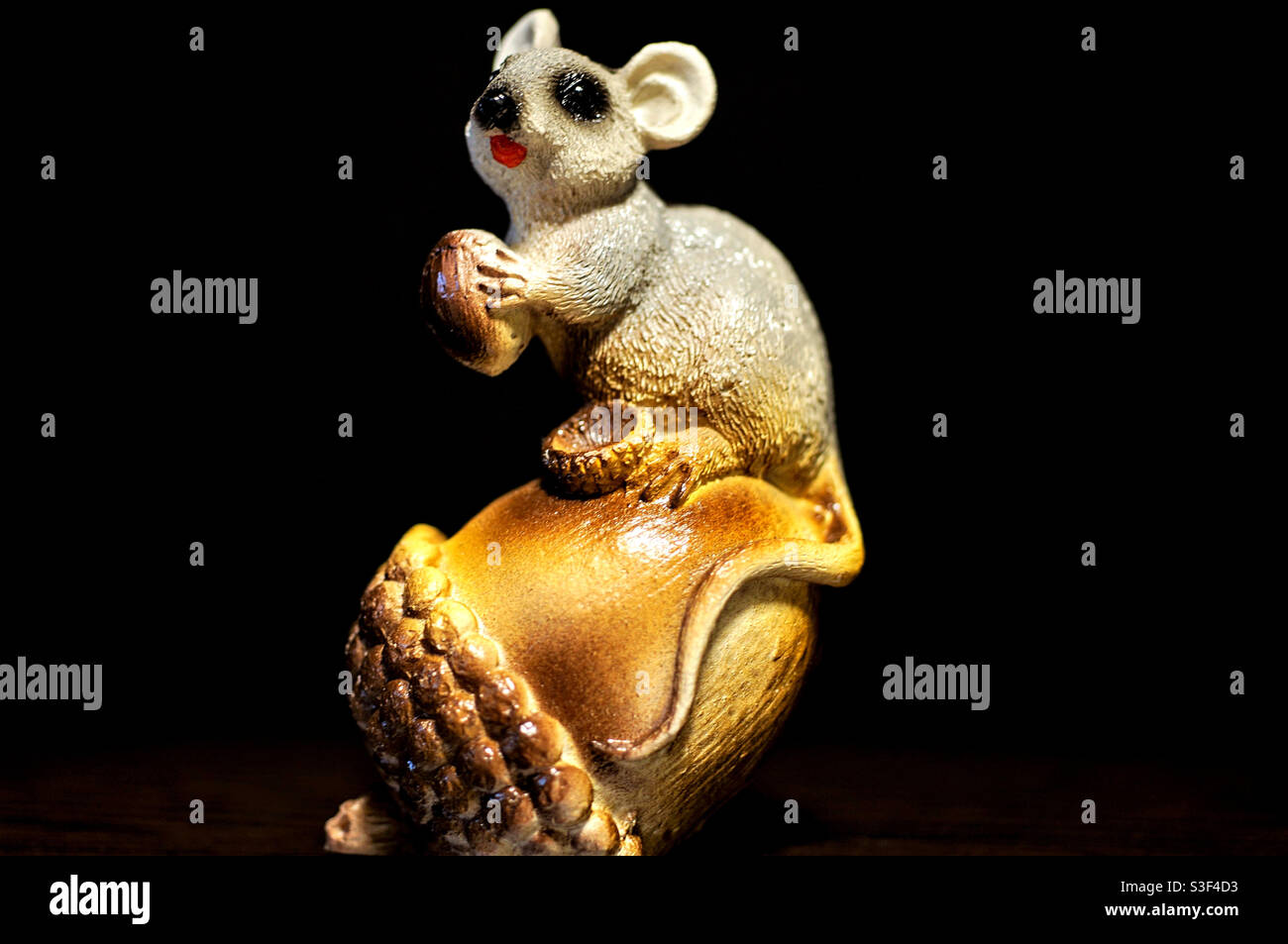Toy gray mouse sitting on a large acorn Stock Photo - Alamy