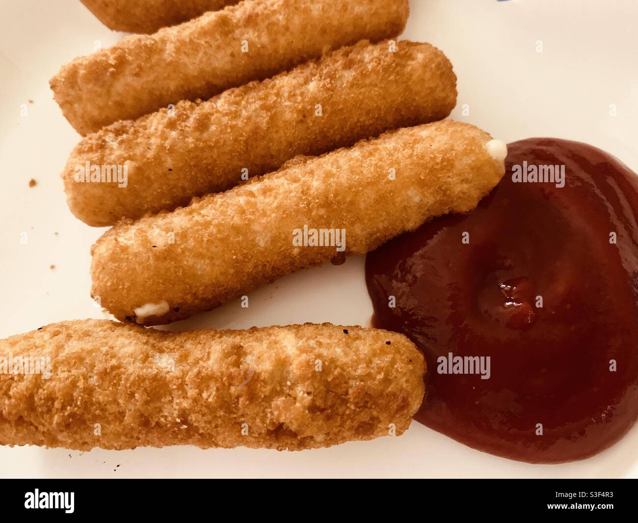 Golden cheese sticks with ketchup for dipping Stock Photo - Alamy