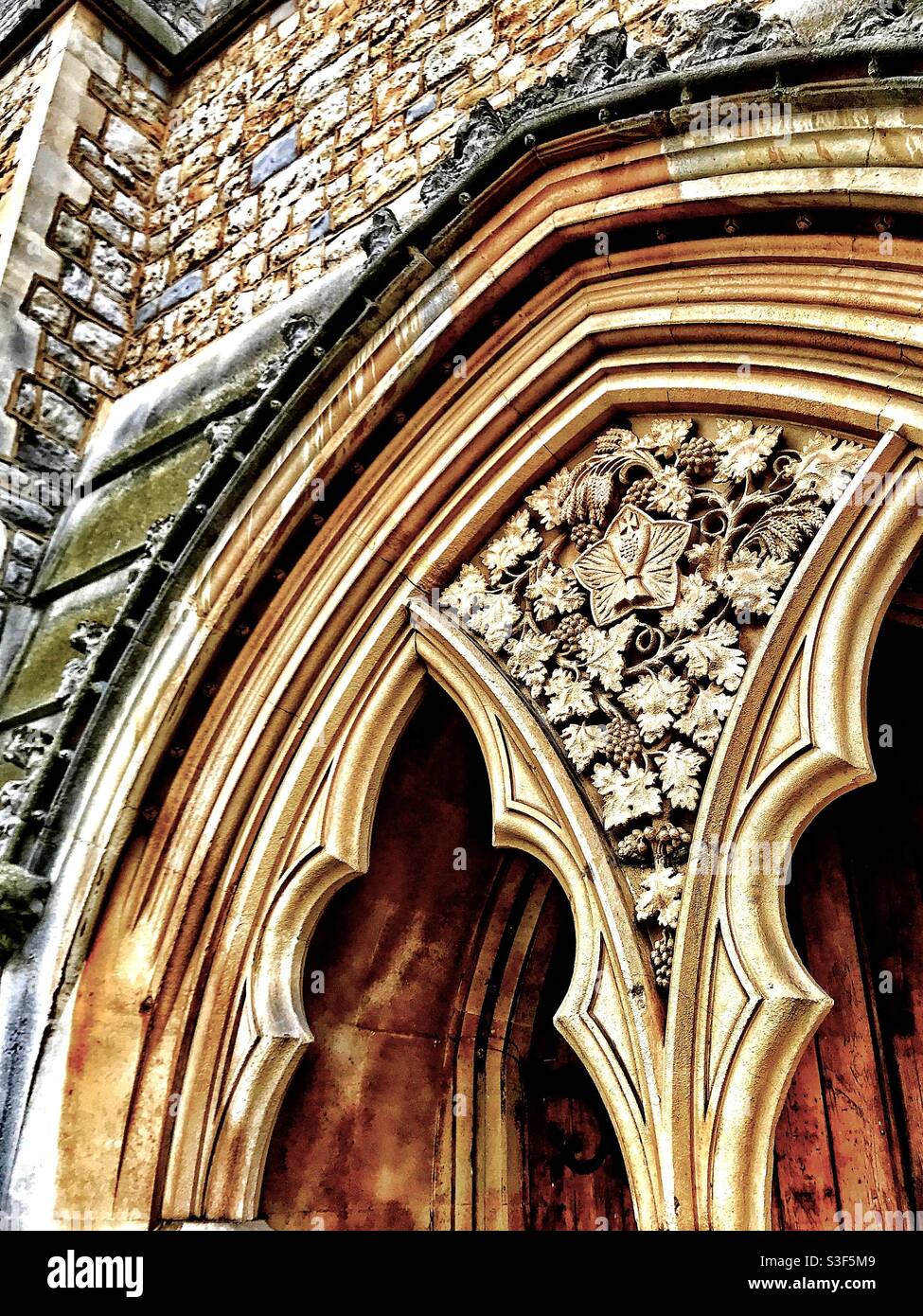 Ornate Gothic entrance arch of the 14th century style Victorian Holy ...