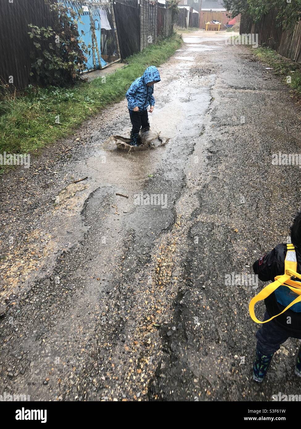 Boy jumping in puddle hi-res stock photography and images - Alamy