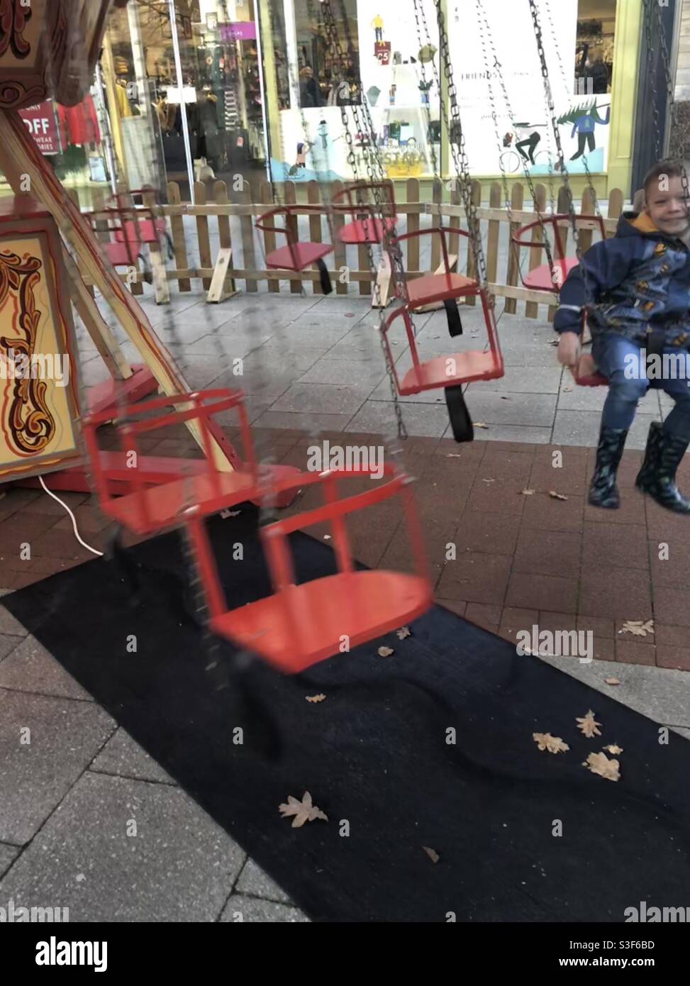 Boy in swing chair ride Stock Photo - Alamy