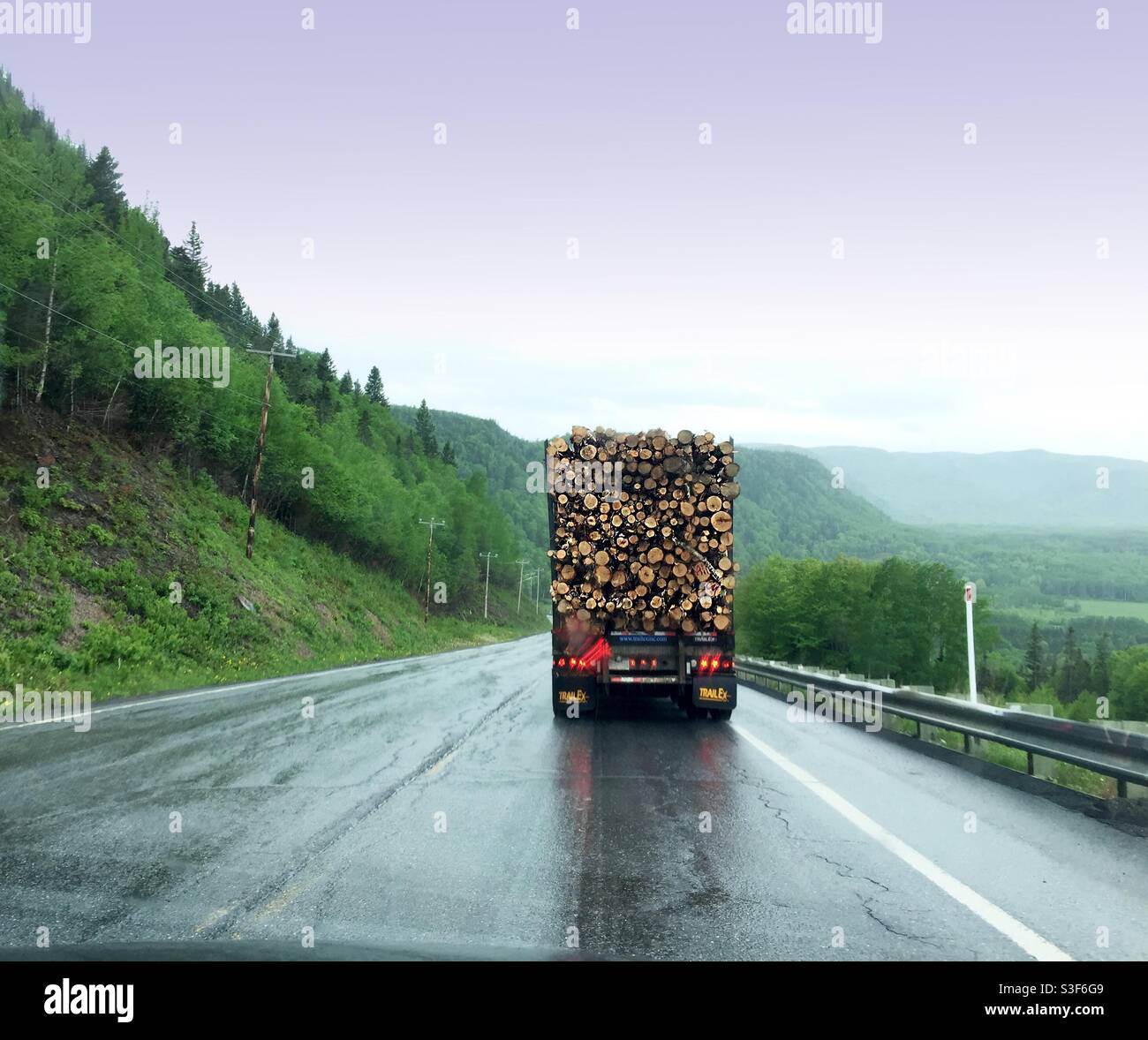 Transporting lumber. Logs on a truck, Canada Stock Photo - Alamy