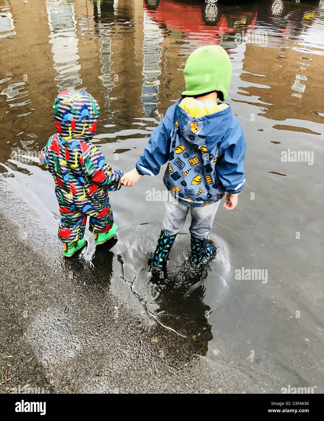 Raincoats boots hi-res stock photography and images - Alamy