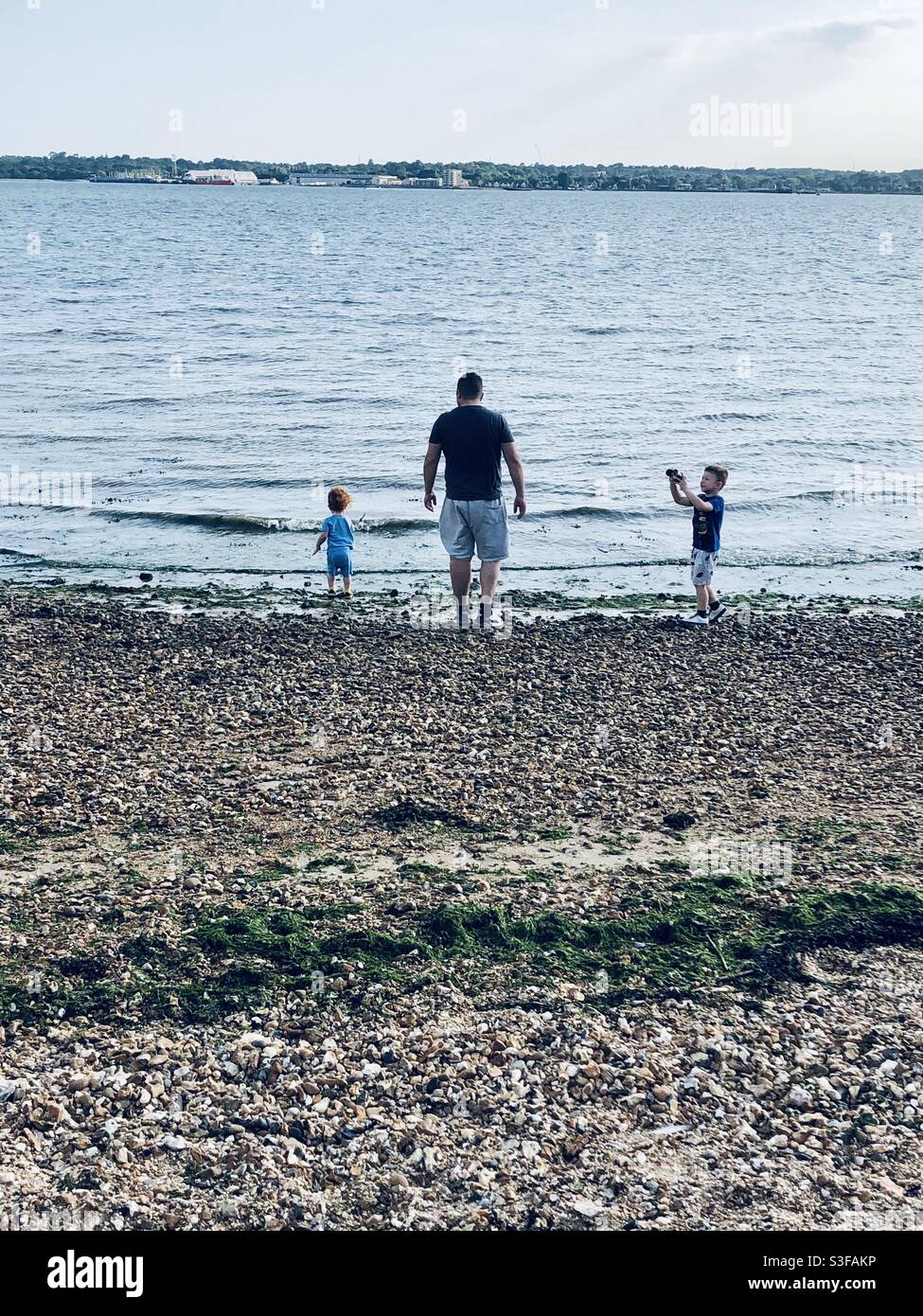 Father and sons on beach hi-res stock photography and images - Alamy