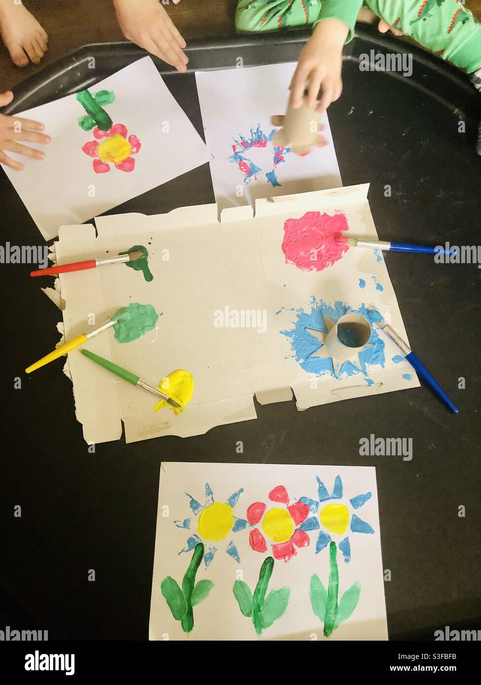 Kids painting flowers Stock Photo - Alamy