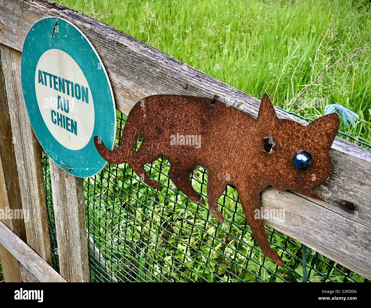 Humorous warning sign in French « Attention au chien » (attention DOG ...