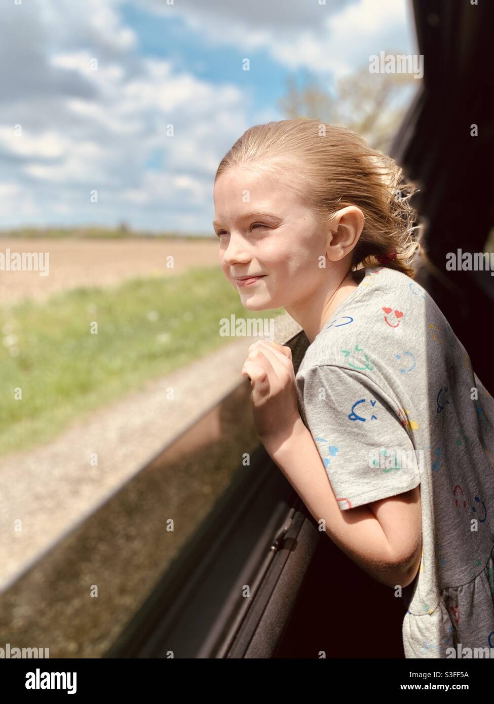 Young girl looking out the car window with the window down Stock Photo ...
