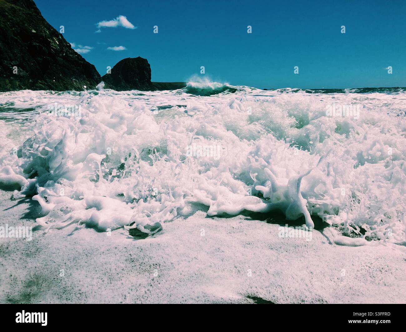 Waves crashing on a beach in Cornwall Stock Photo - Alamy