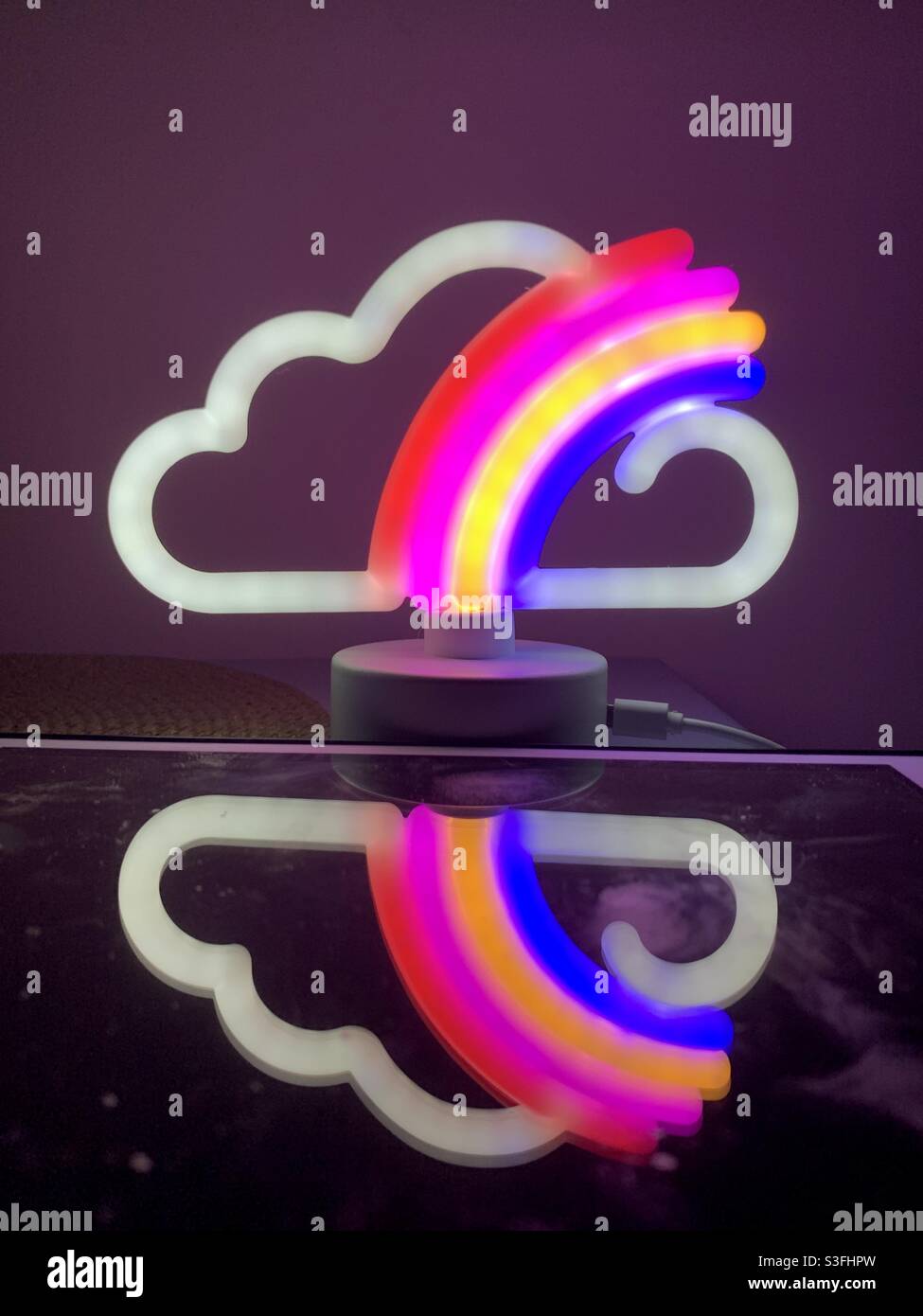 Neon rainbow light reflected on glass surface Stock Photo - Alamy