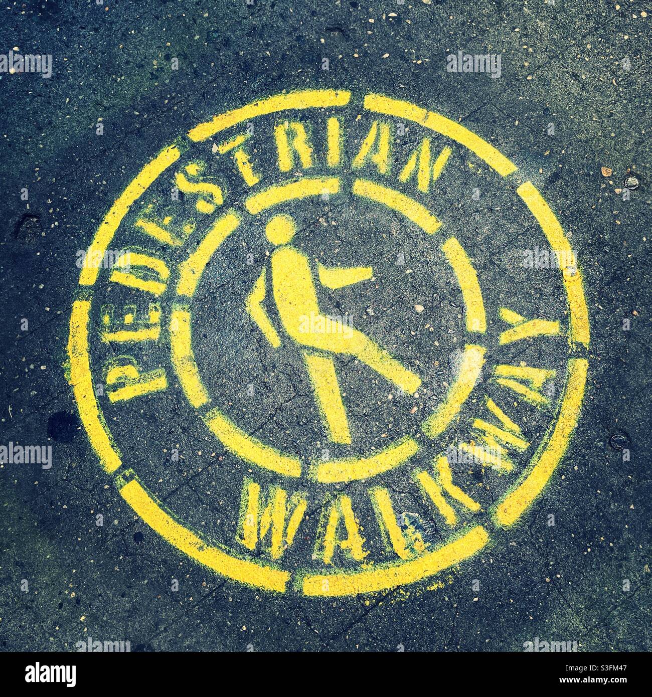 A painted pedestrian walkway stencil on a Manhattan sidewalk, NYC, USA ...