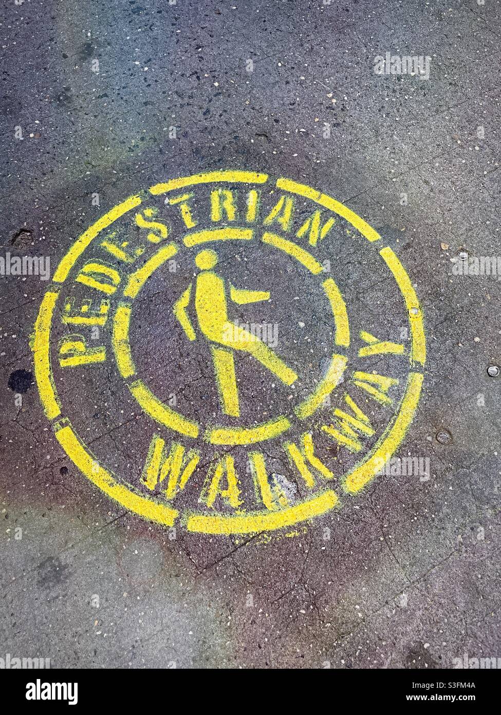 A painted pedestrian walkway stencil with pictogram on a New York City ...