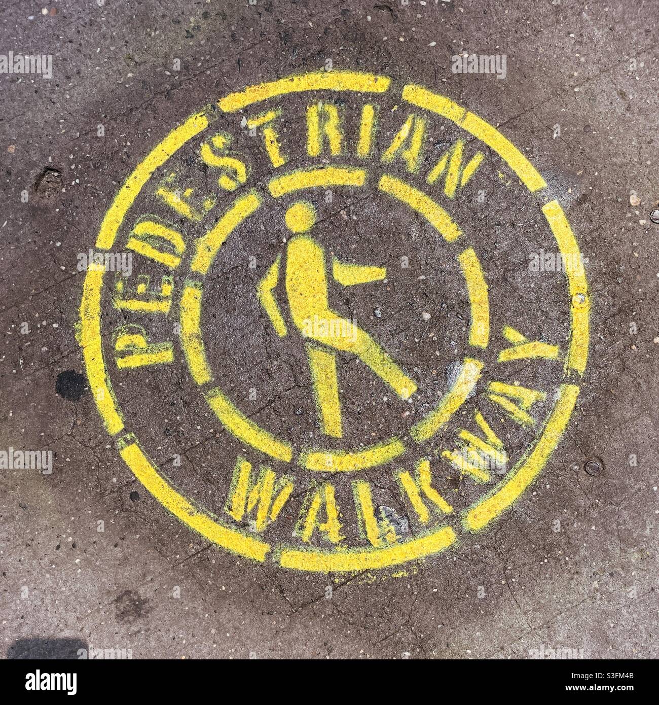 Pedestrian walkway stencil in yellow paint on a Manhattan sidewalk, NYC ...