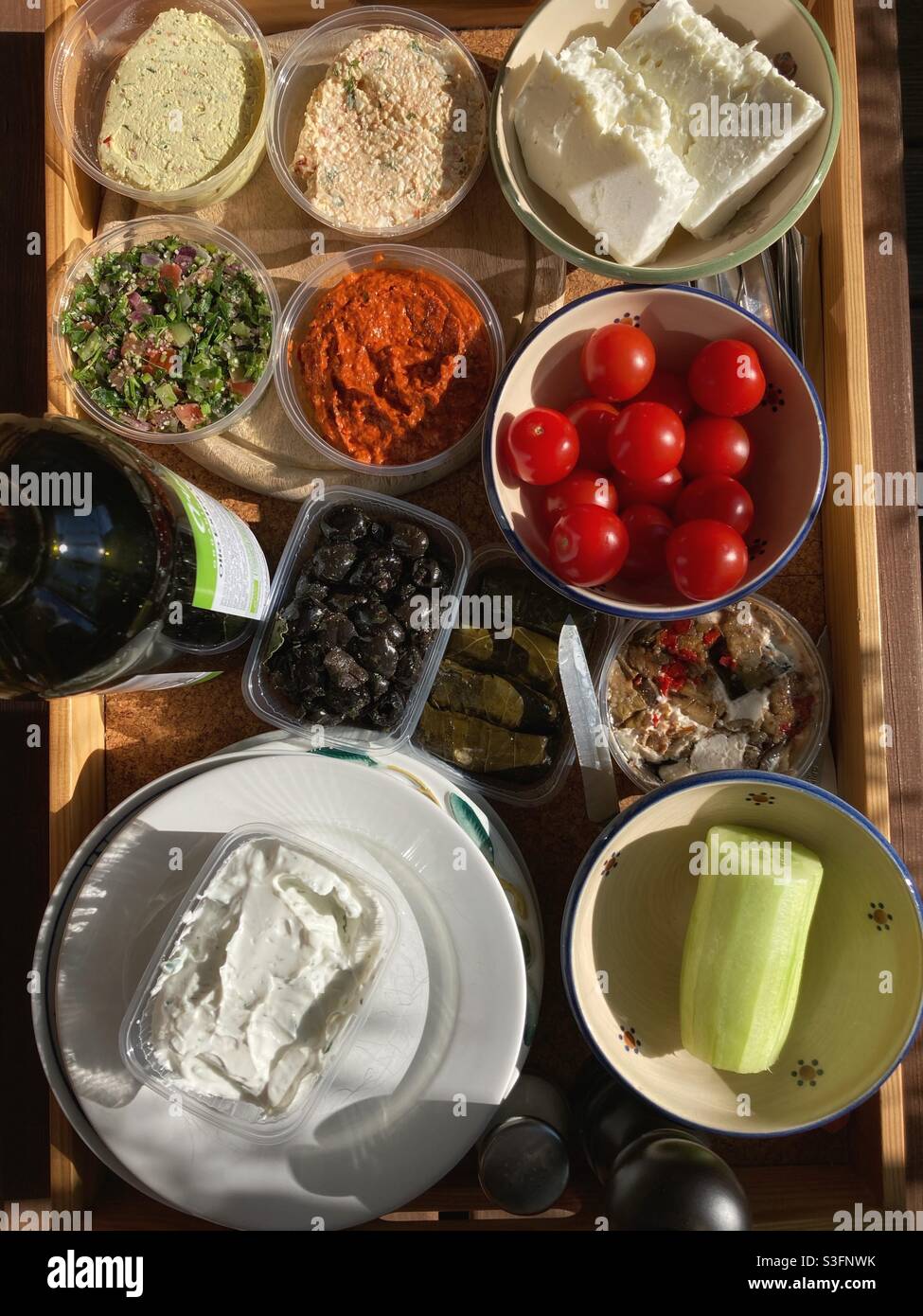 An Assortment of different fresh dips, olives, cheese, tomatoes and ...