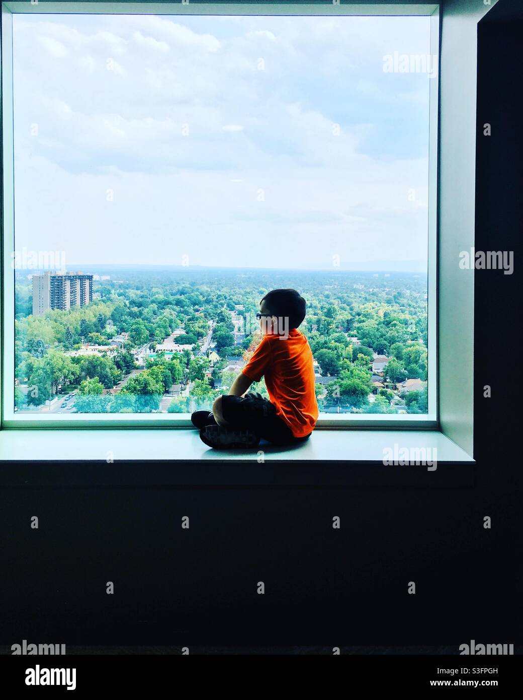 Boy in a window Stock Photo - Alamy