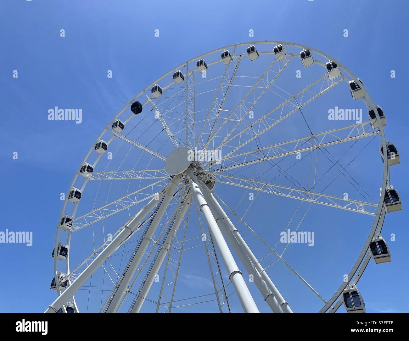 Large outdoor sky wheel with clear blue sky background Stock Photo - Alamy